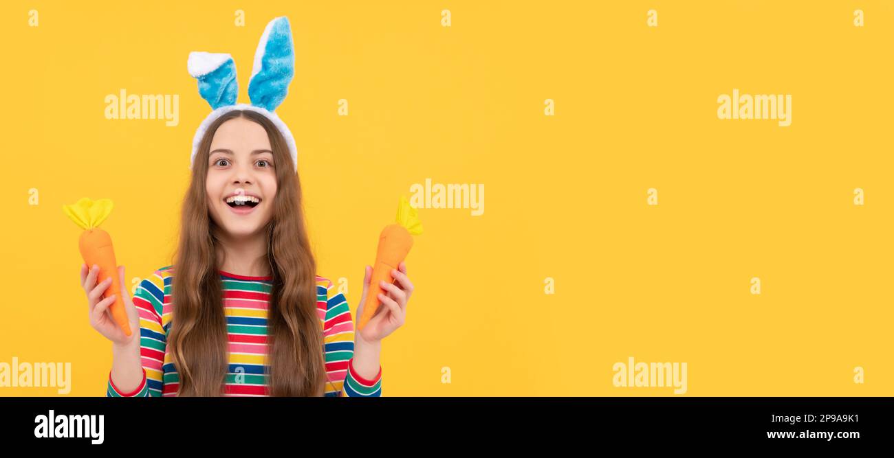 happy easter teen girl in rabbit bunny ears holding carrot for holiday ...