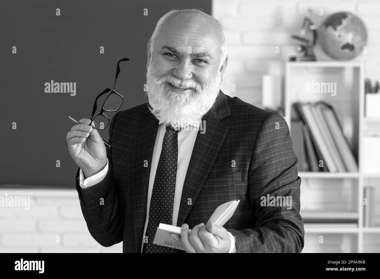 Grey hair funny happy smiling professor in empty lecture classroom ...