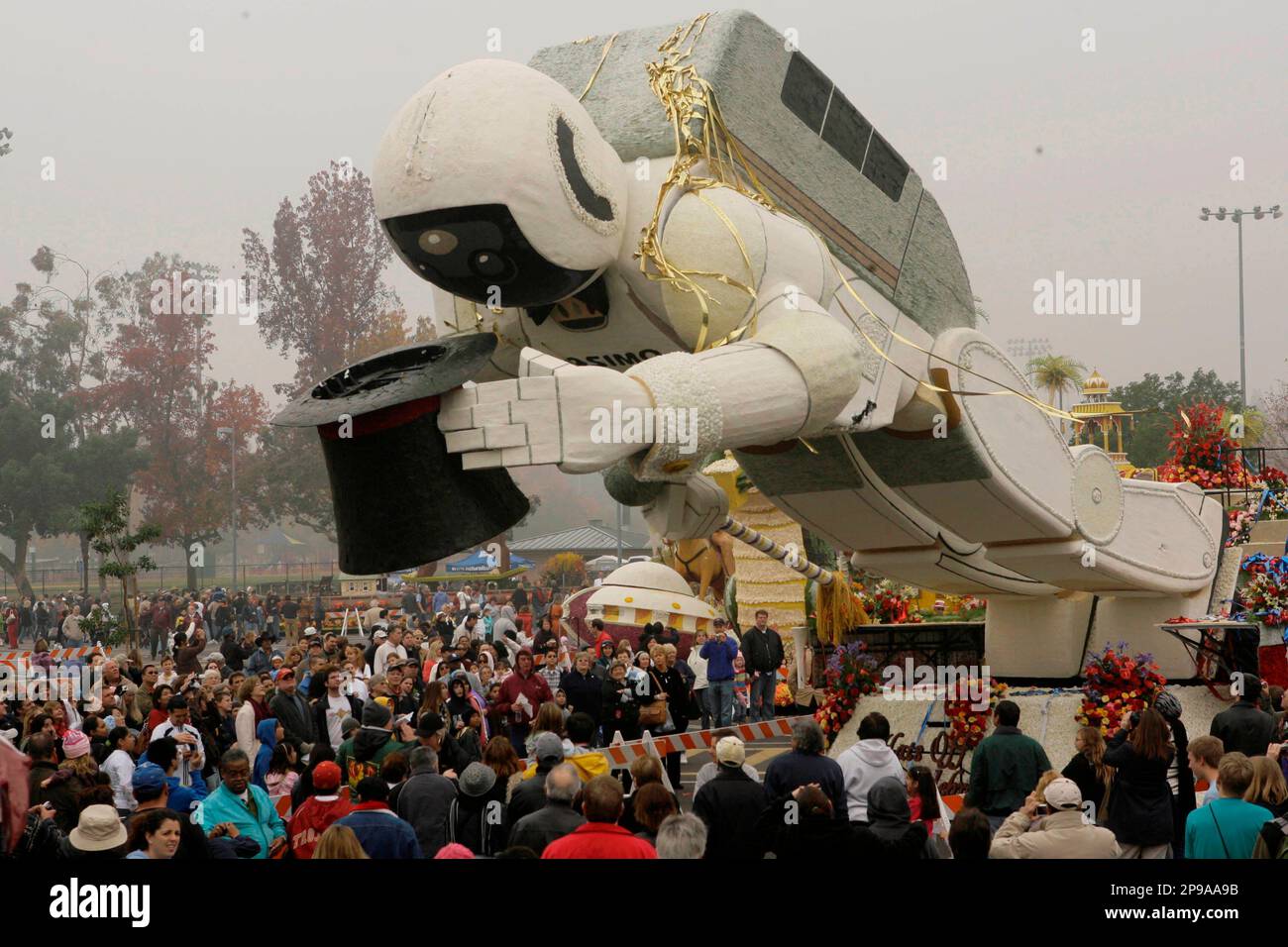 Pedestrians gather around the Honda in America float featuring a ...