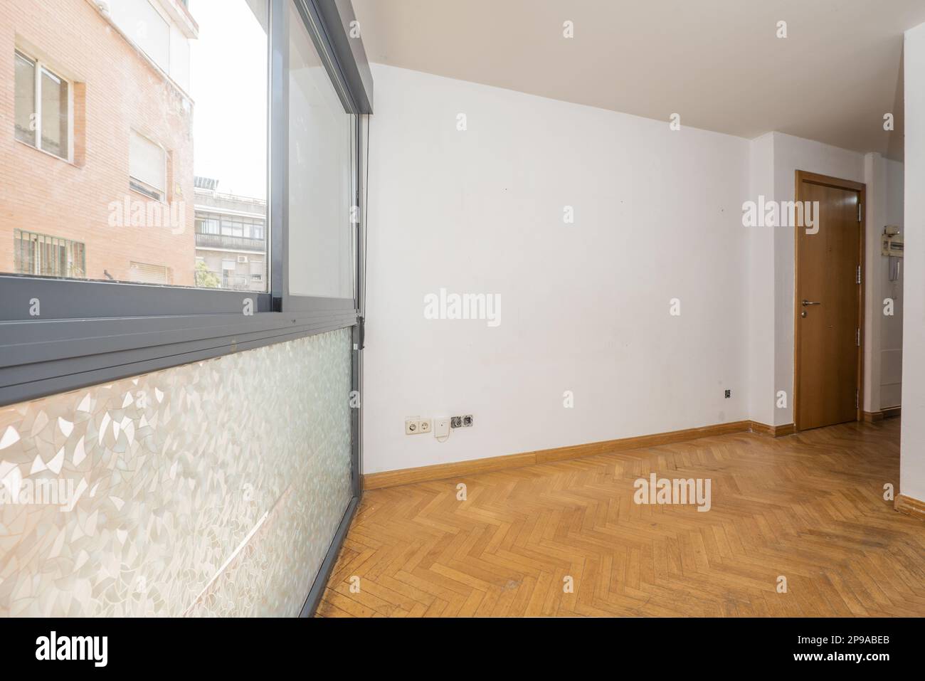 Empty living room with a large gray anodized aluminum window with glass ...