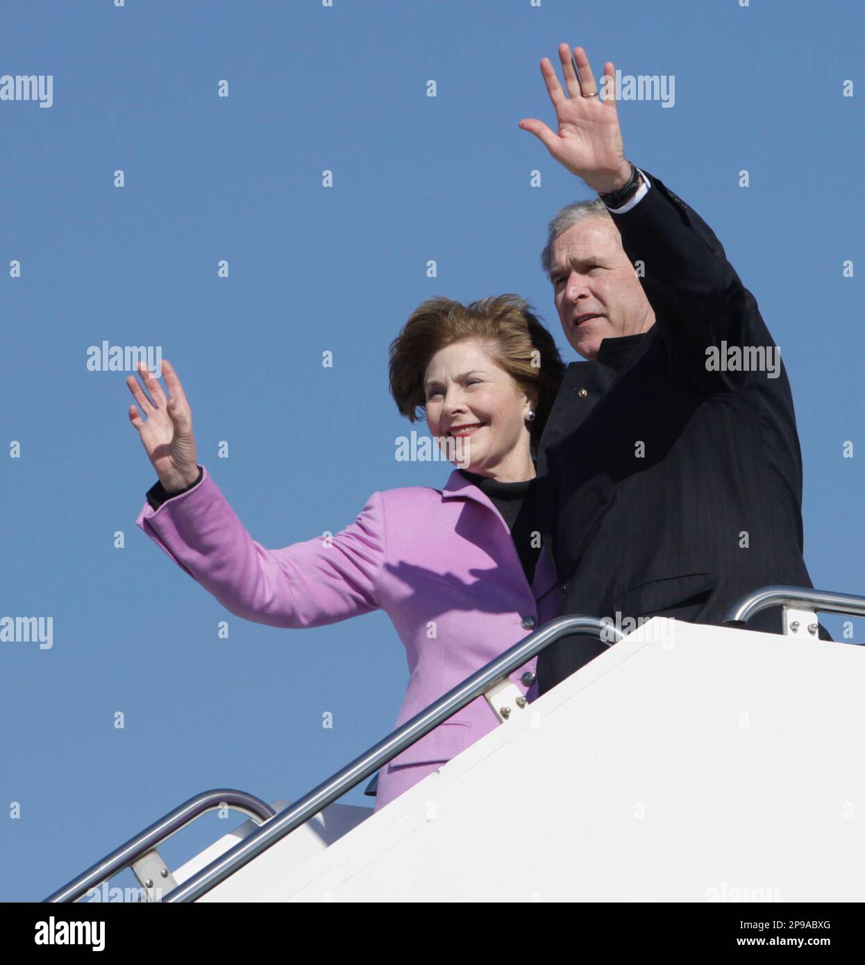 President George W. Bush and first lady Laura Bush wave as they board ...