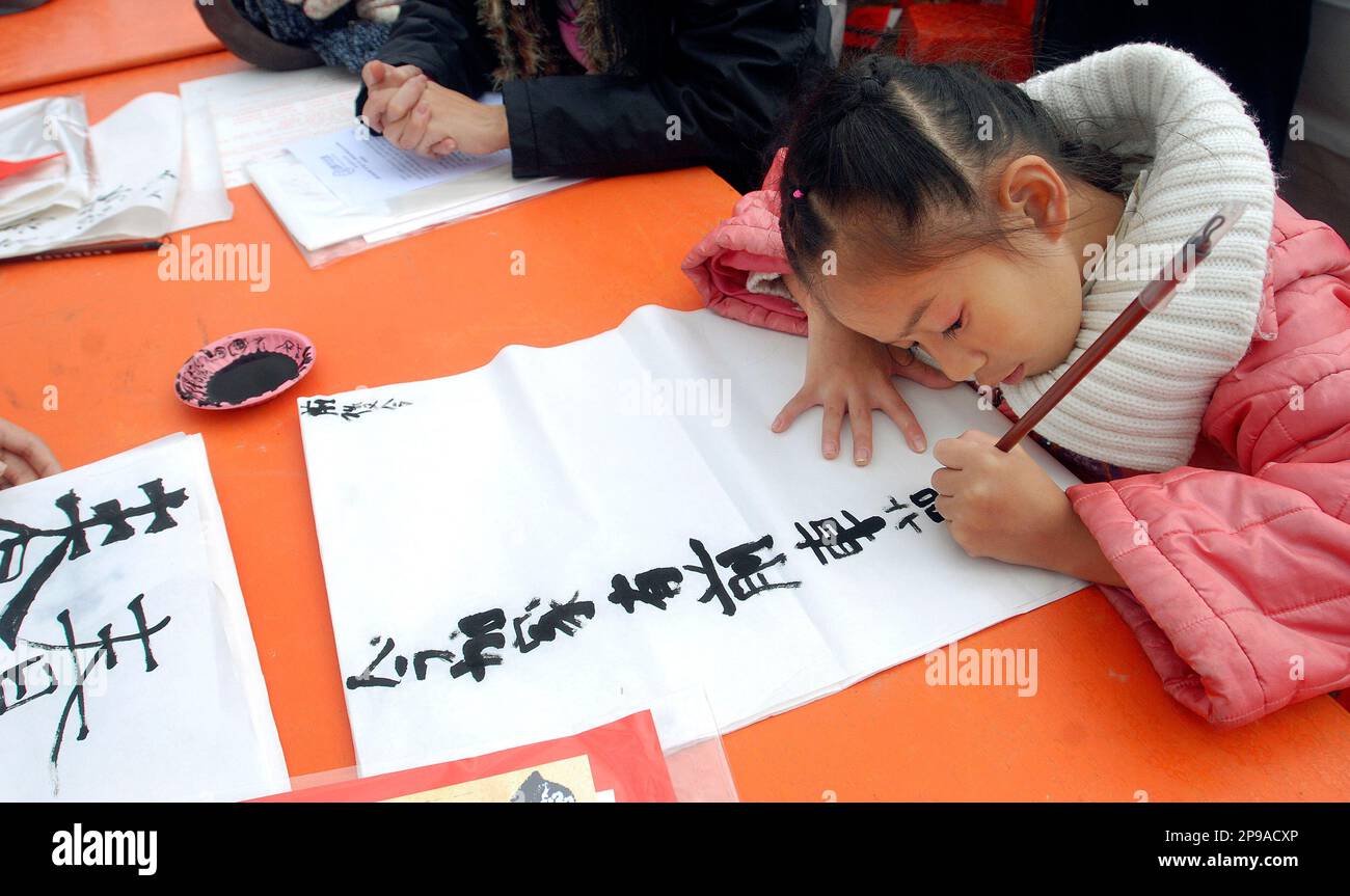 A Taiwanese girl writes traditional Chinese calligraphy with a hair ...
