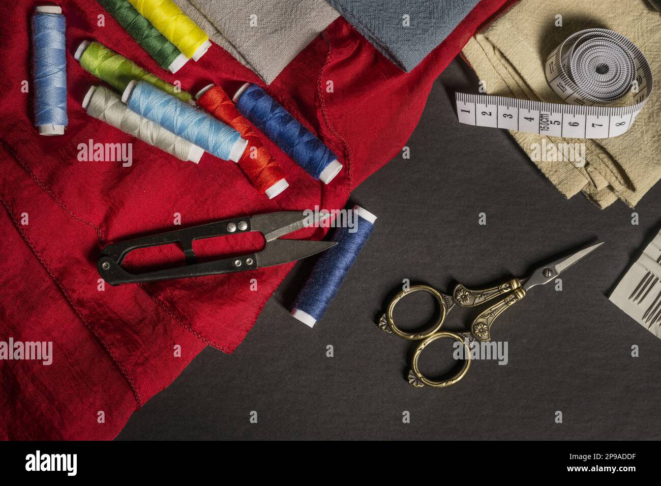 Still life with seamstress objects with golden vintage scissors, rolled ...