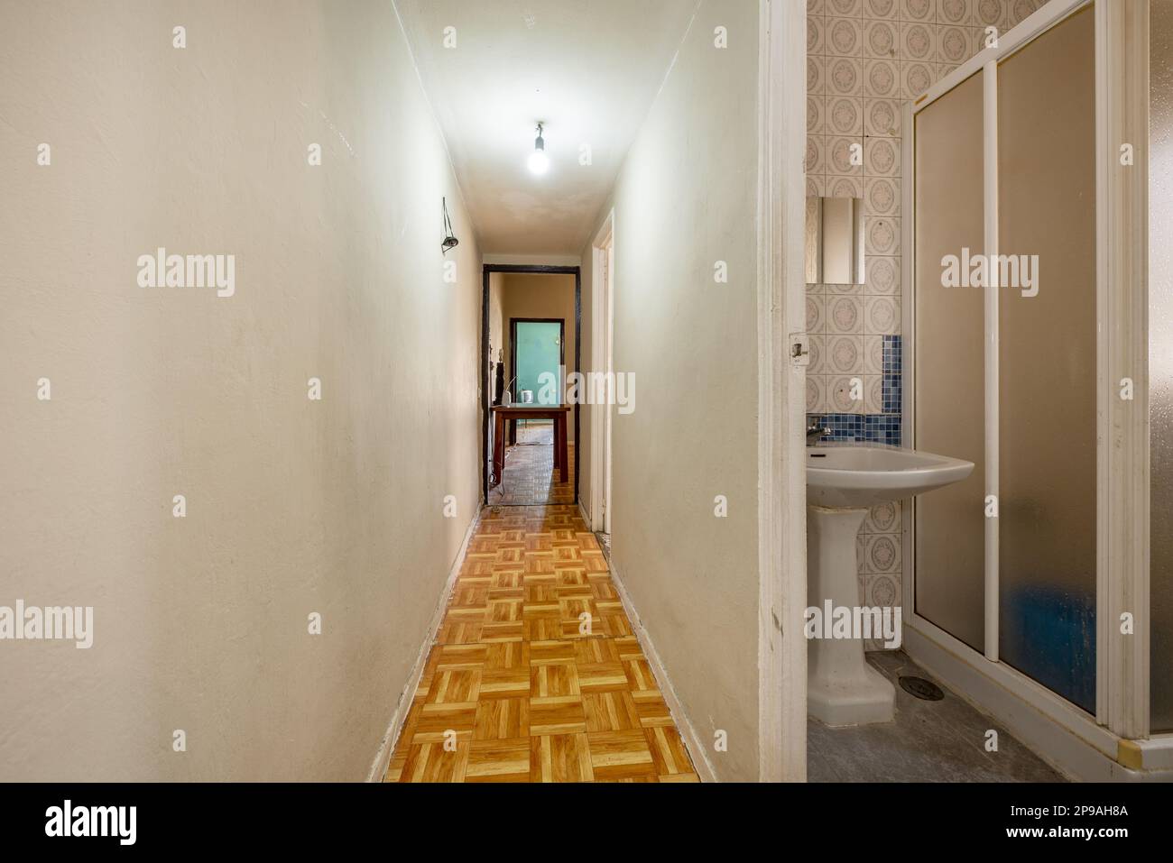 Corridor in an old, dirty and ugly house and access to a bathroom in ...