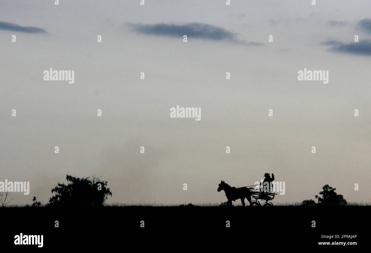 A man rides a horse cart in San Cristobal, Cuba, Sunday, Dec.28, 2008 ...