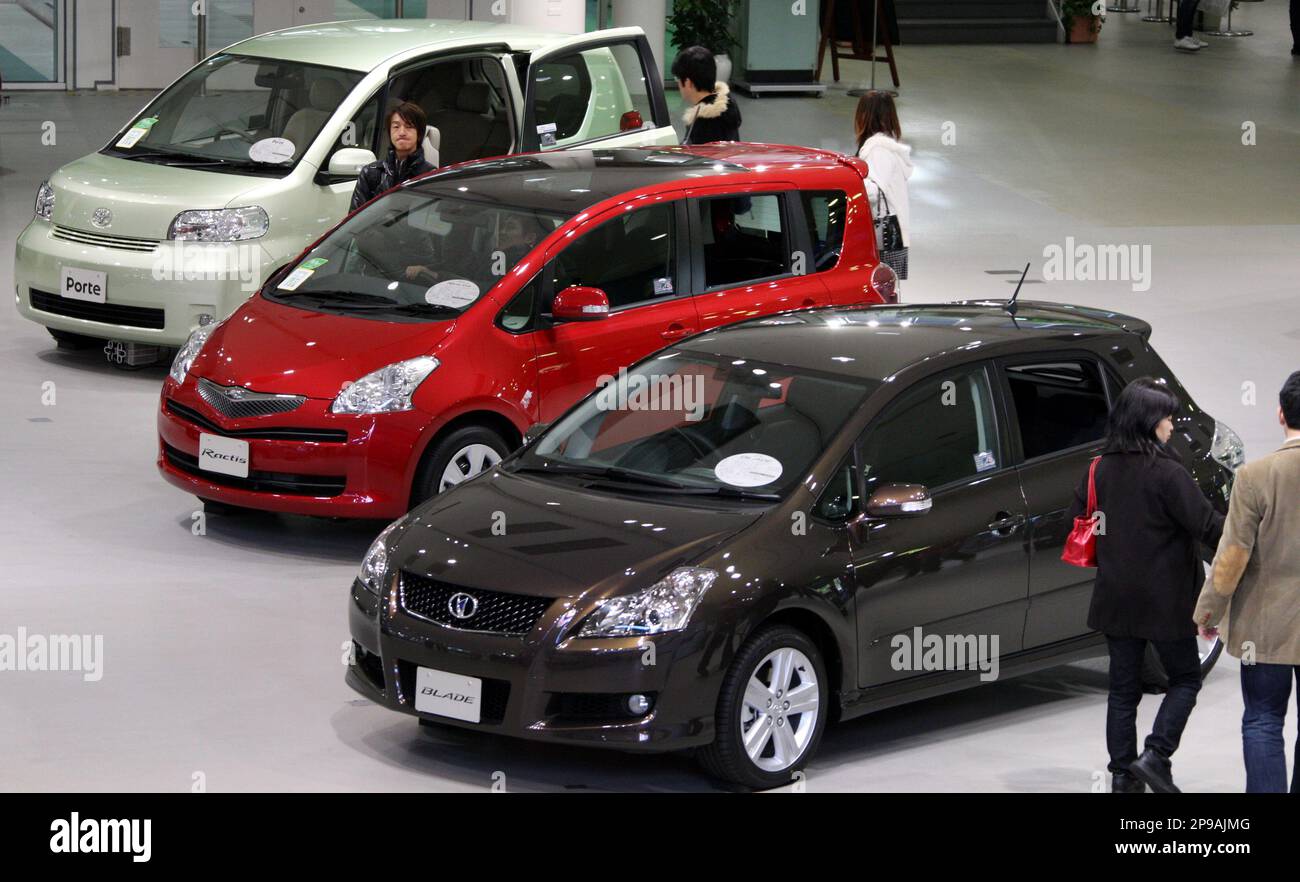 Visitors look at Toyota Motor Corp.'s vehicles on display at the ...