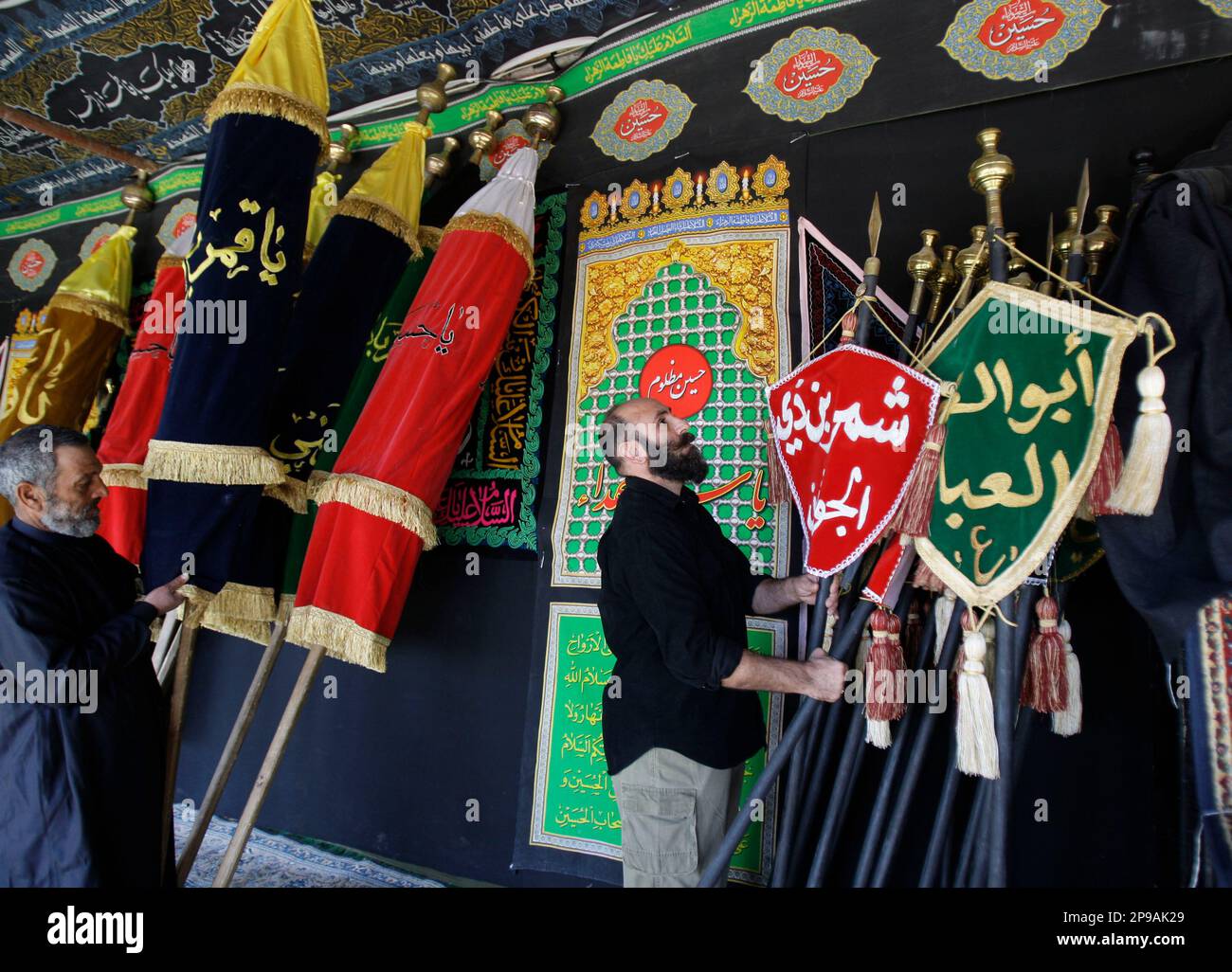 Iraqis prepare for the Muharram procession in the Shiite neighborhood ...
