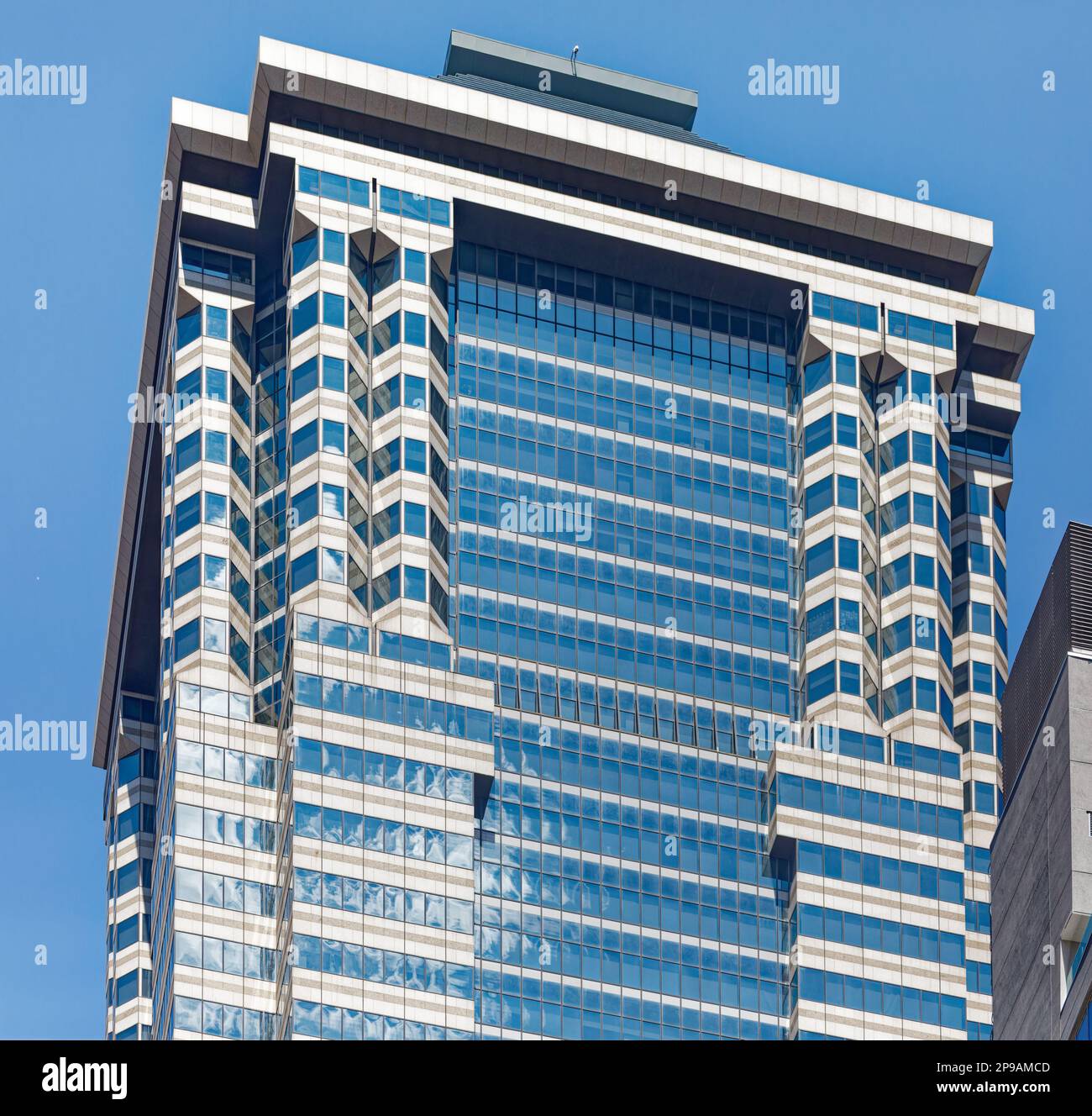 Stone and glass curtain walls and columns emphasize the vertical at 60 ...