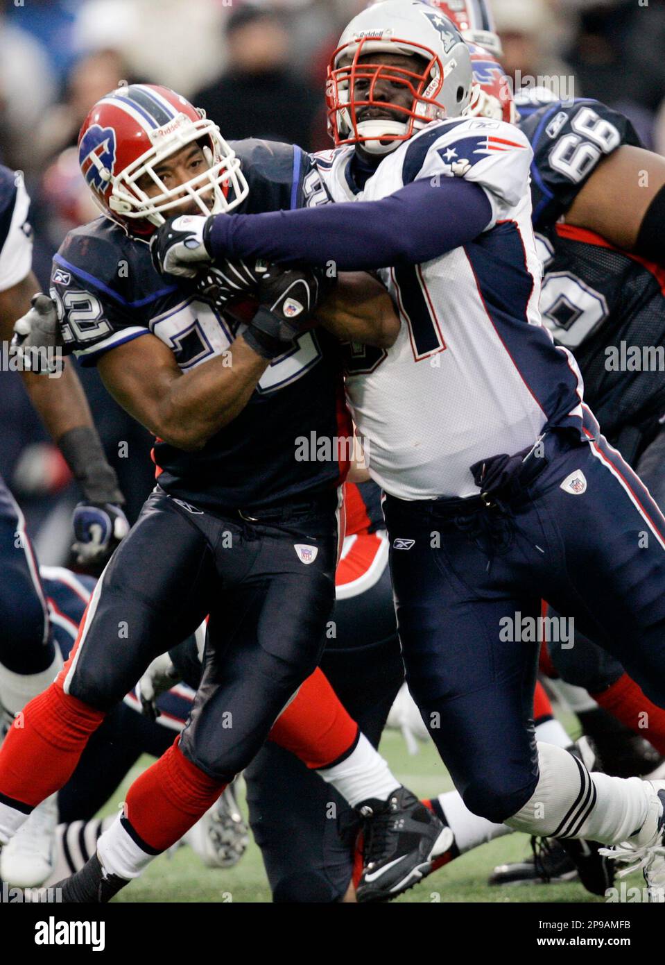 Buffalo Bills' Fred Jackson (22) is tackled by New England Patriots' Jarvis Green (97) during ...