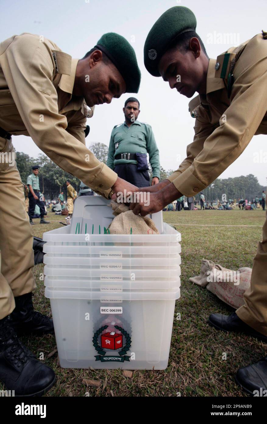 Security personnel get ready to carry ballot boxes and other election ...