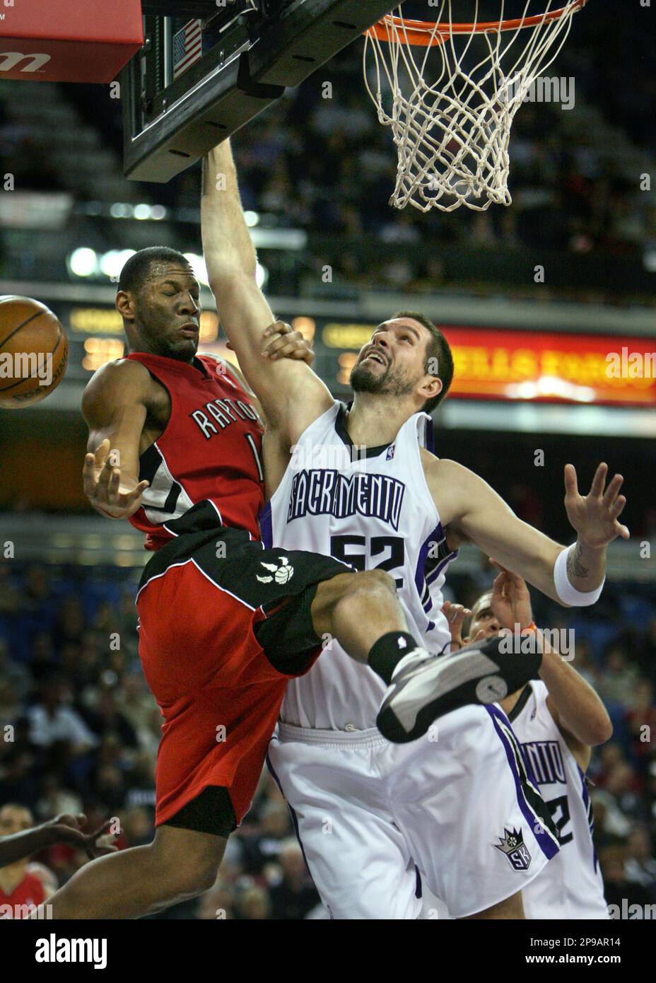 Toronto Raptors forward Joey Graham, left, is fouled under the basket ...