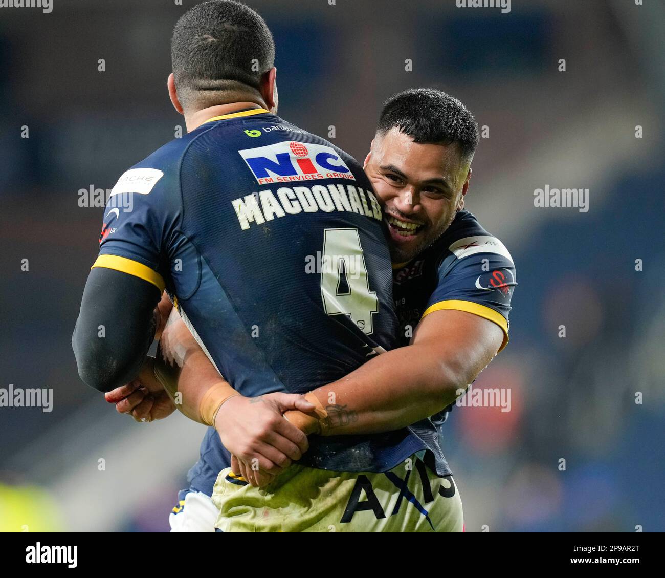 Sam Lisone #15 of Leeds Rhinos wrestles with Nene Macdonald #4 of Leeds ...