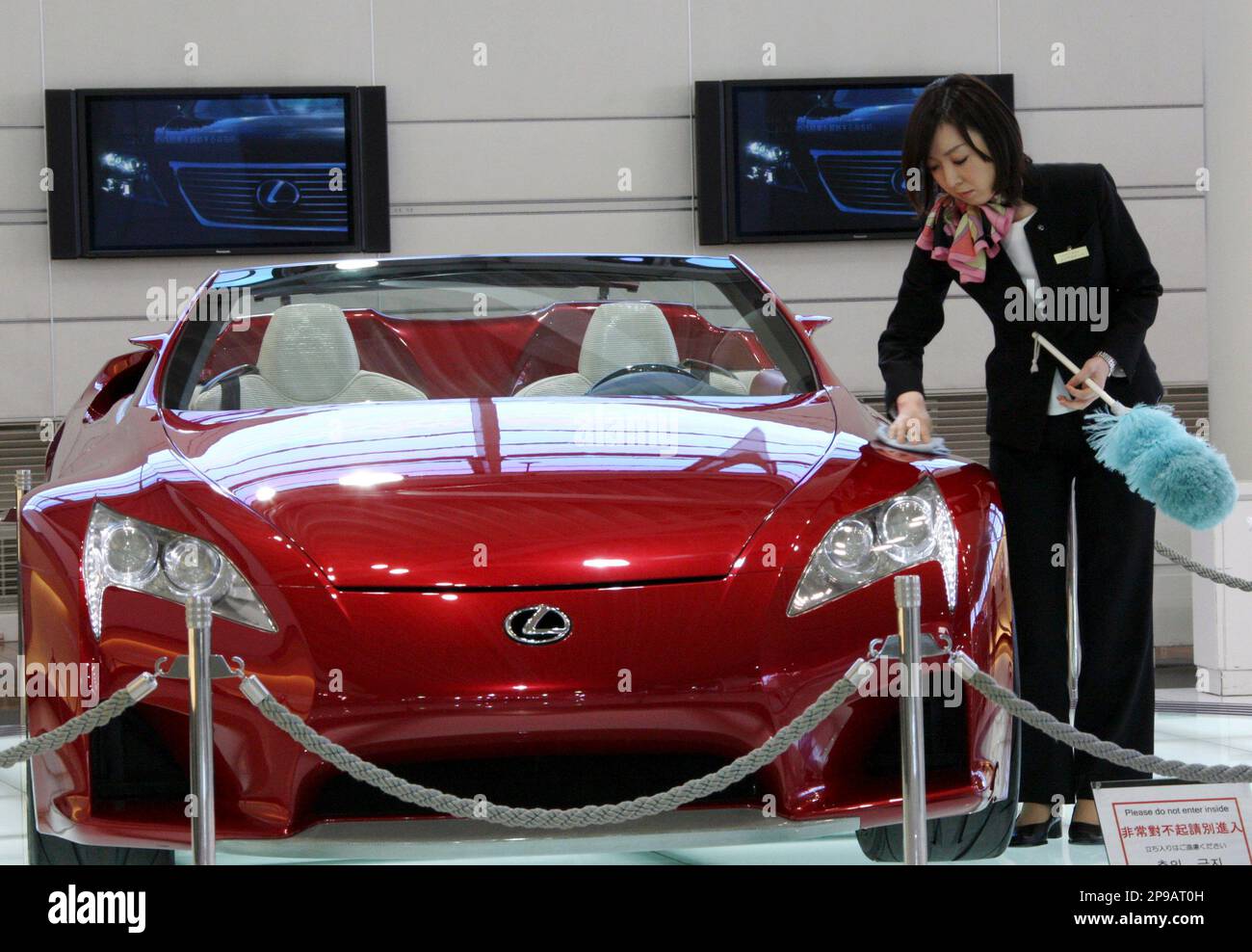 A woman staff dusts off Toyota Motor Corp's Lexus concept car LF-A ...