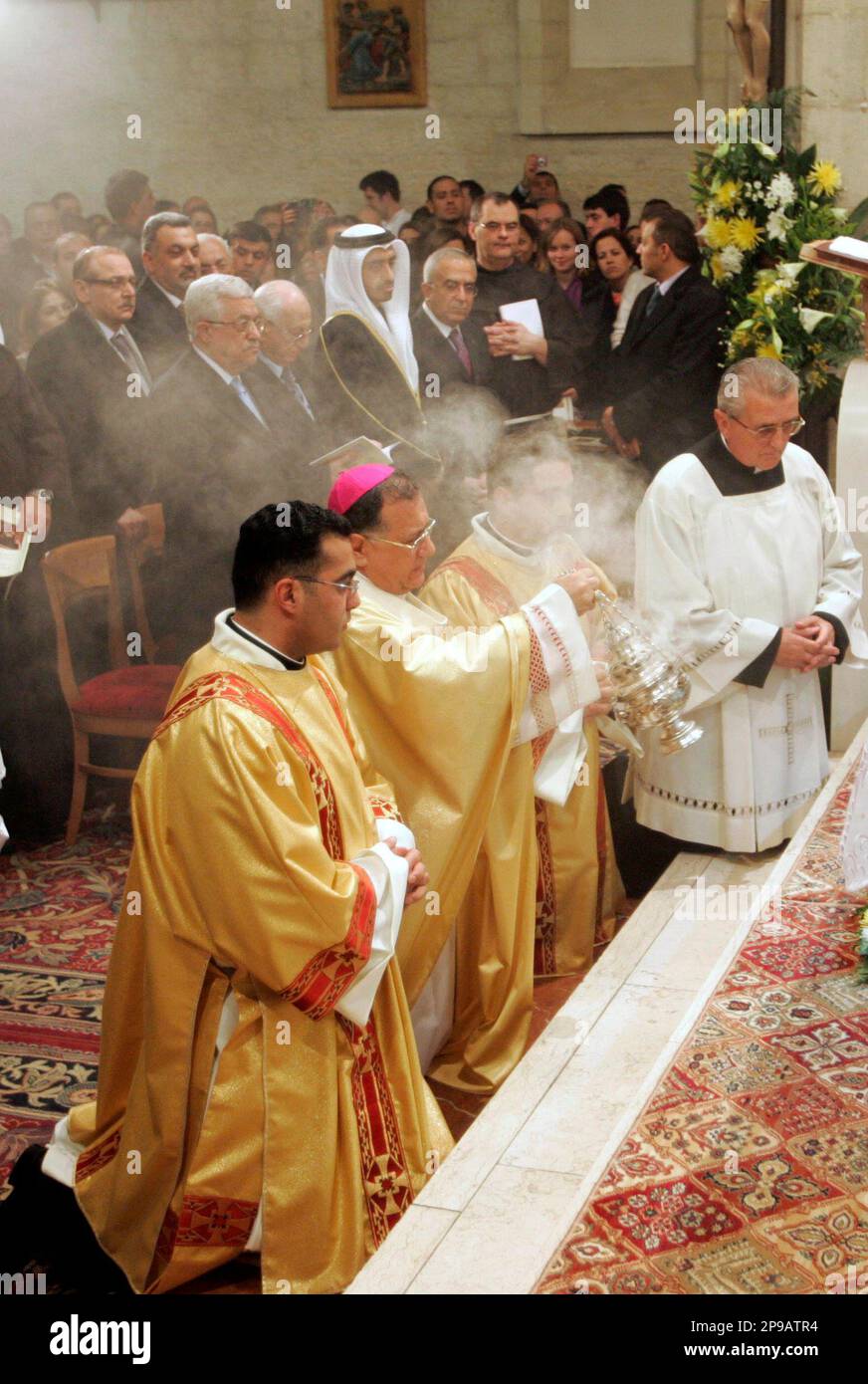 Latin Patriarch of Jerusalem Fouad Twal, center, leads the Christmas ...
