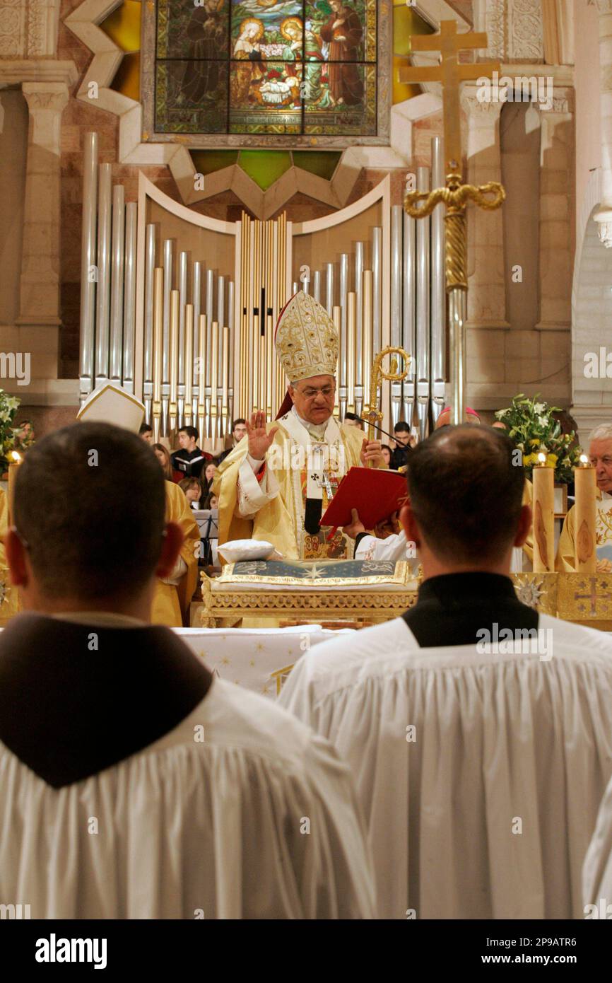 Latin Patriarch of Jerusalem Fouad Twal, center, leads the Christmas ...