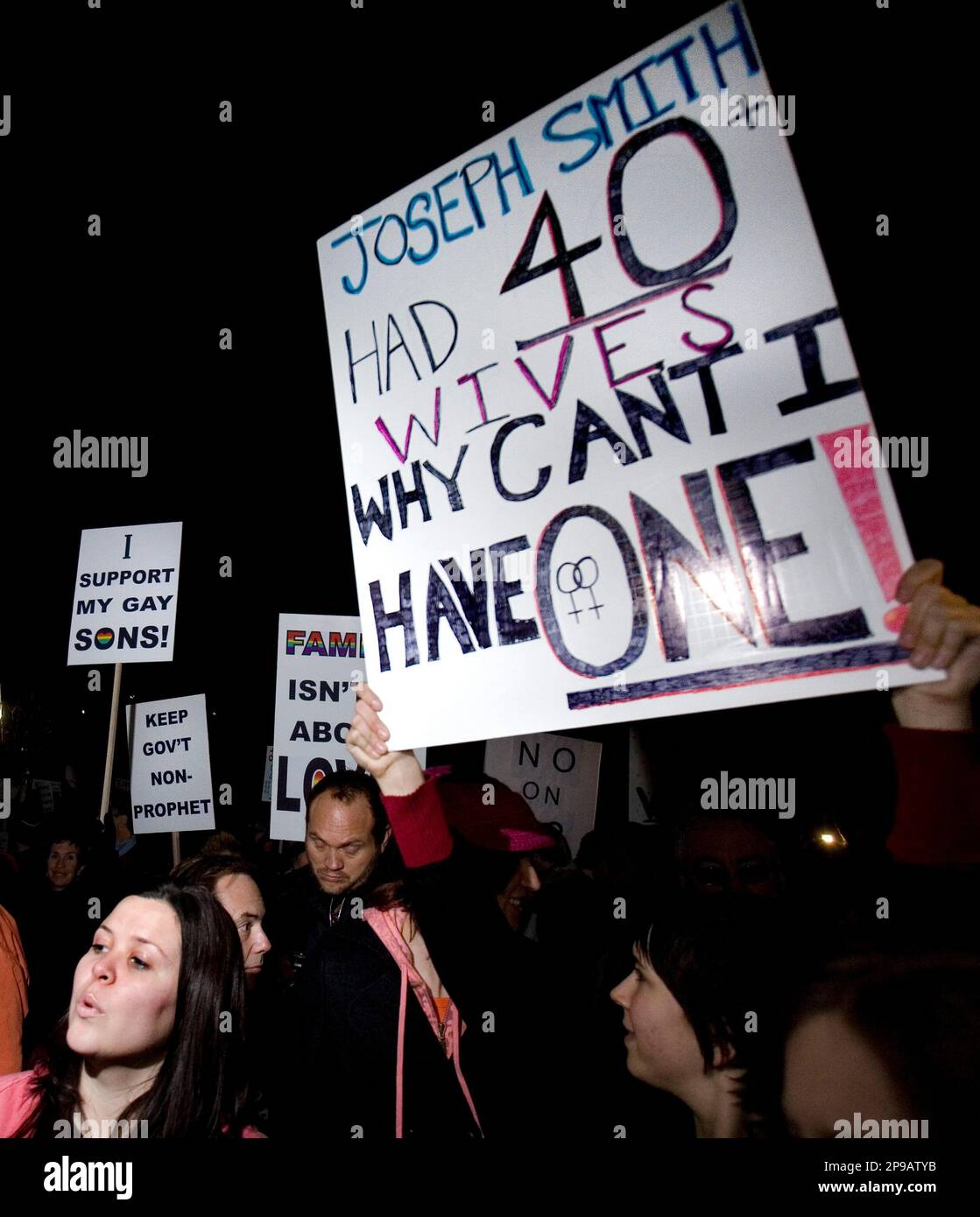 ** FILE ** People gather before marching on the Mormon Temple in ...