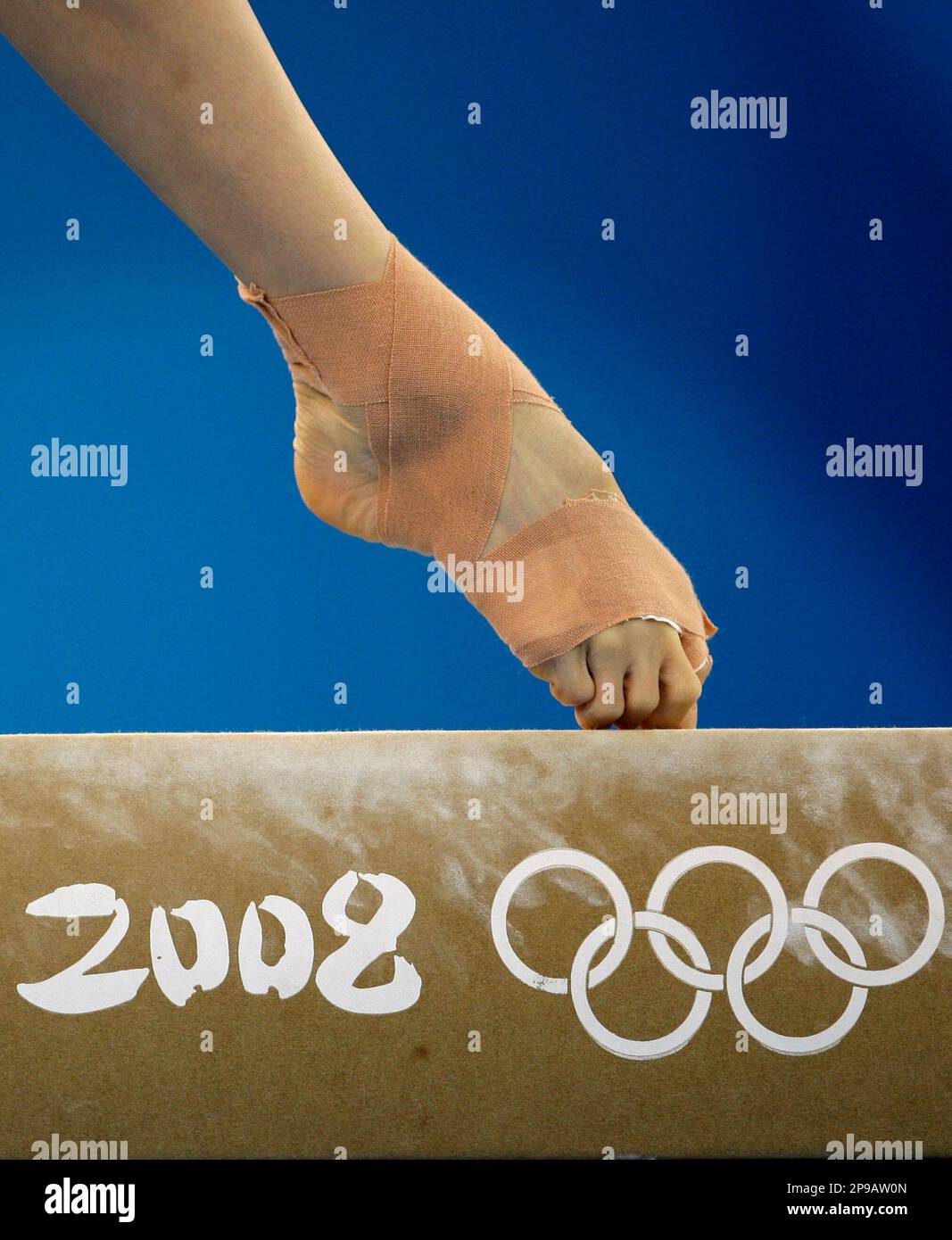 A Chinese gymnast performs on the balance beam during a podium training ...