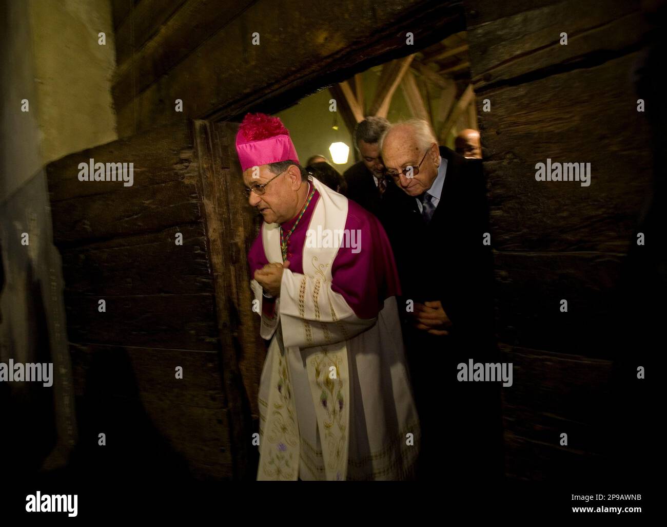 Latin Patriarch of Jerusalem Fouad Twal, left, enters at the Church of ...