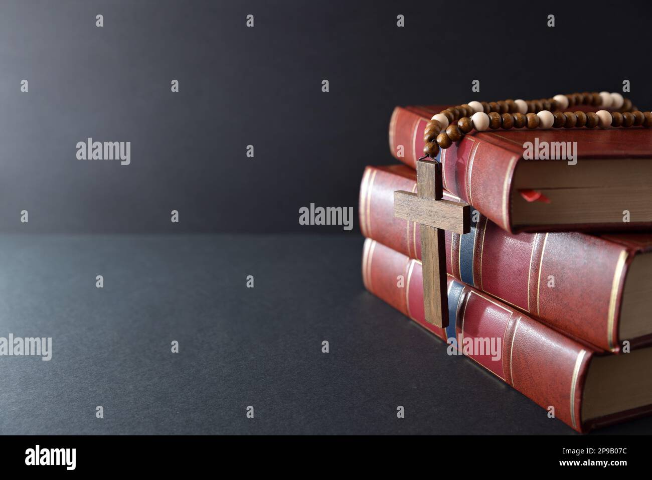 Background with stack of religious books and religious cross with chain ...