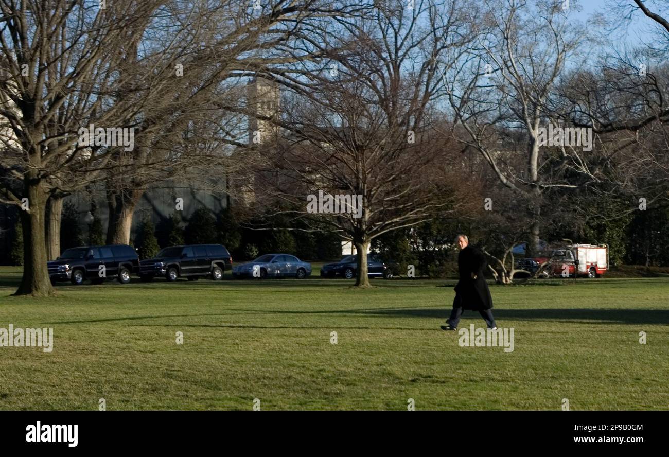 President George W. Bush, walks across the South Lawn after arriving at ...