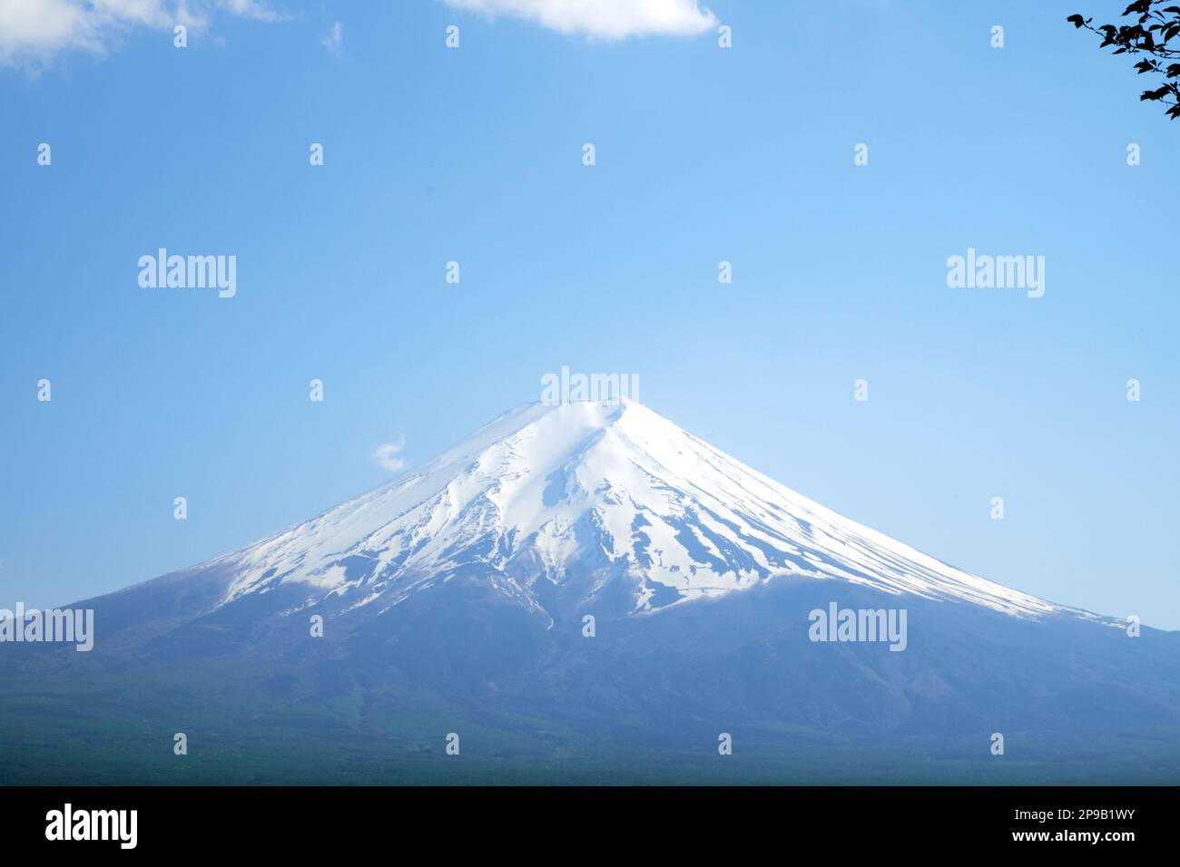 A view of Mount Fuji in Japan with snow on top and blue sky as a ...