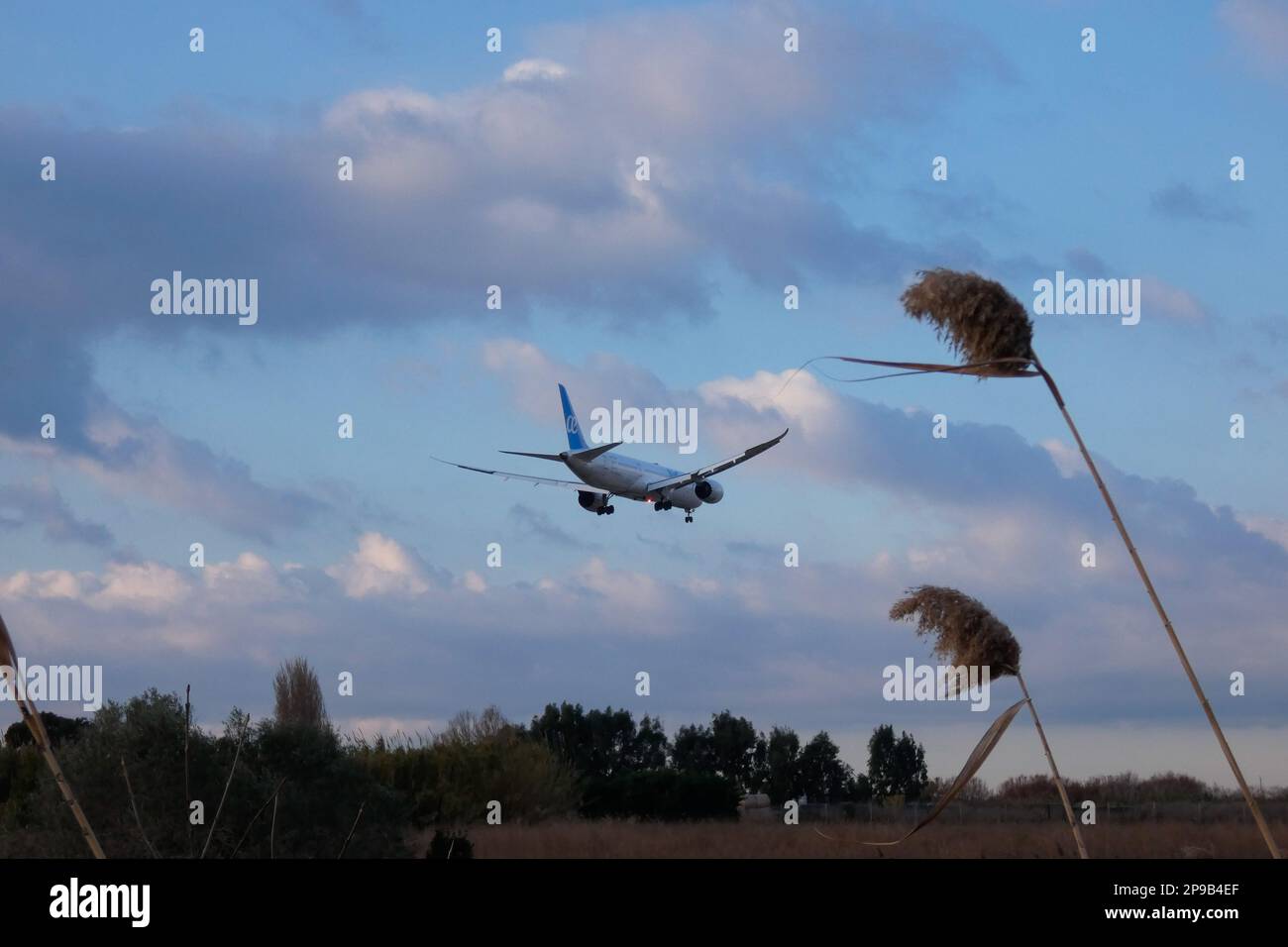 Commercial aircraft overflying the sky and arriving at airport Stock ...