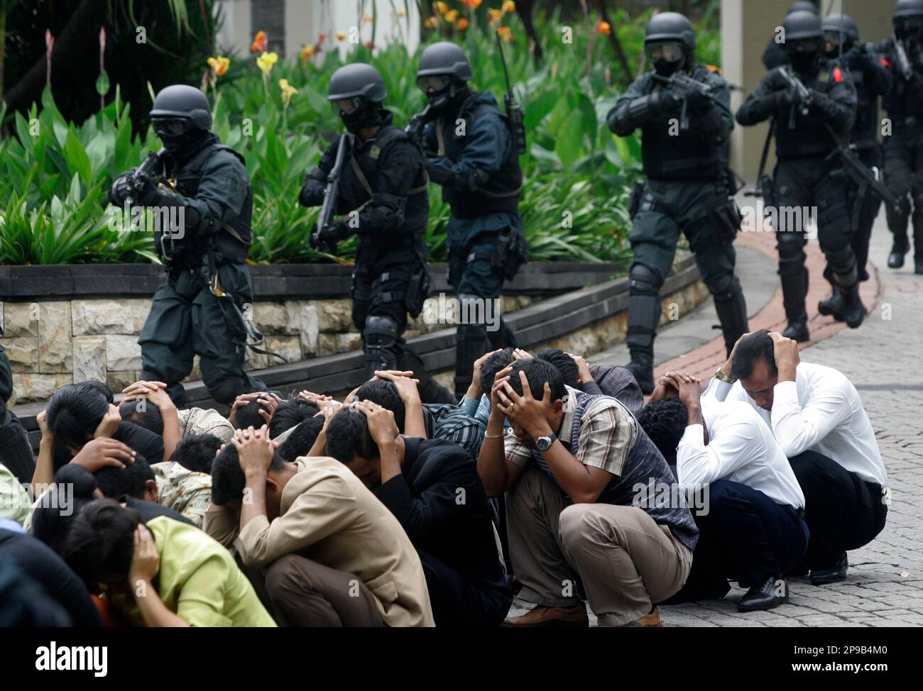 Indonesian special forces soldiers walk past rescued hostages during an ...