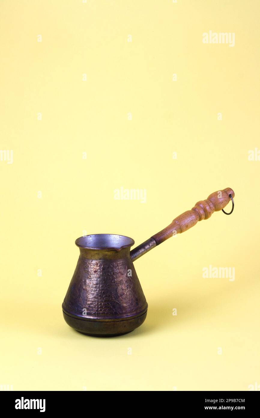 Turkish Cooper Iron old Turk for making boiled coffee on a yellow ...