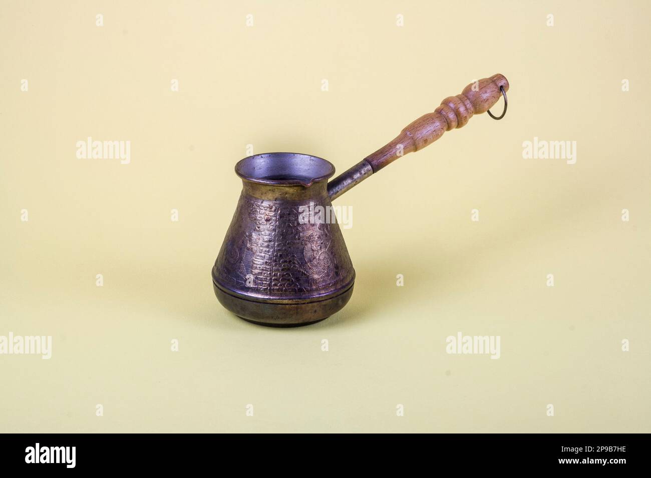 Turkish Cooper Iron old Turk for making boiled coffee on a yellow ...