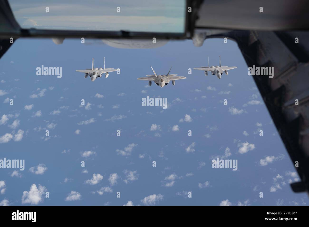 A U.S. Air Force F-22 Raptor, middle, assigned to Joint Base Elmendorf ...