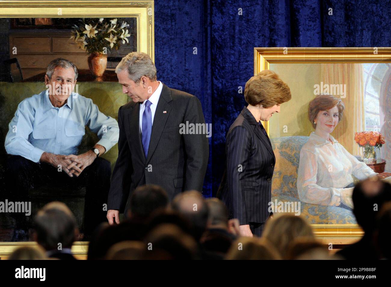 President George W. Bush and first lady Laura Bush look over their ...