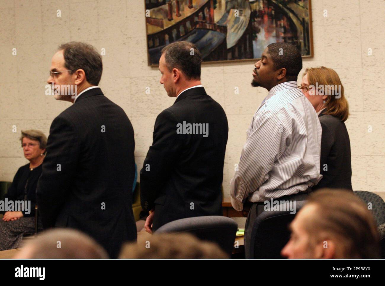 Michael Addison, third from left, stands with his legal team as he ...