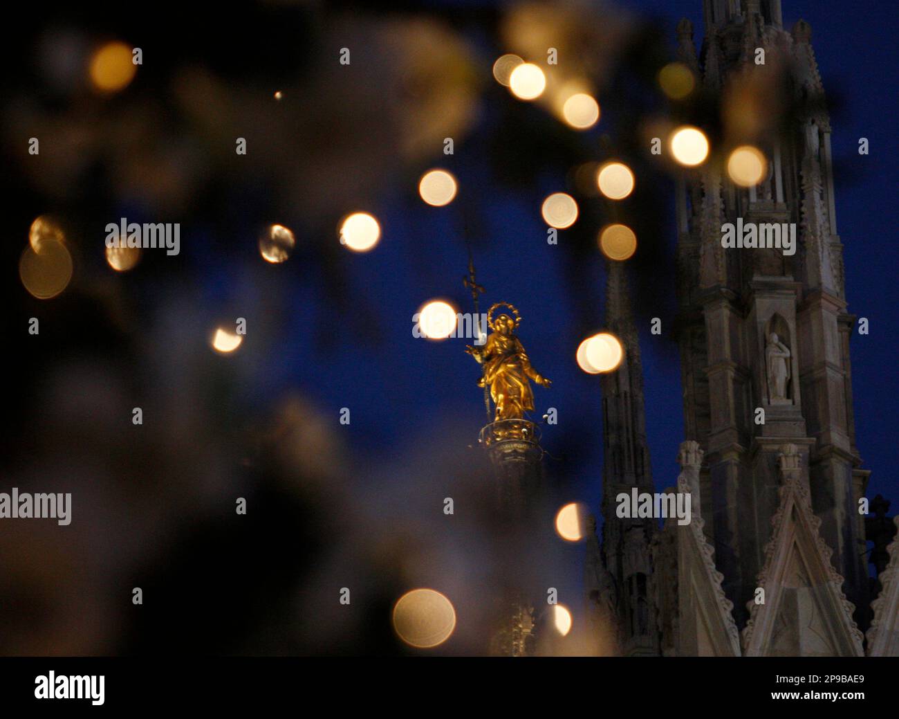 The statue of the Holy Mary, sitting on the highest pinnacle of the ...