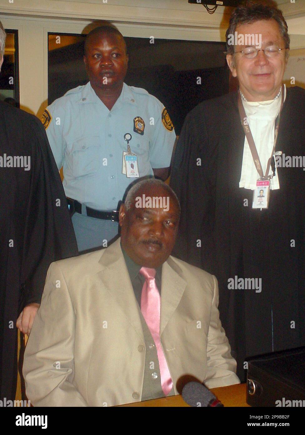 Protais Zigiranyirazo, seated, with his lawyer, right, and a court ...