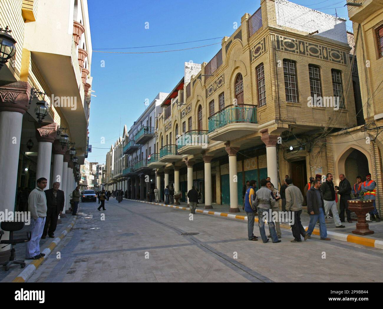 Iraqi people stand around during a reopening of the Mutanabi Street in ...