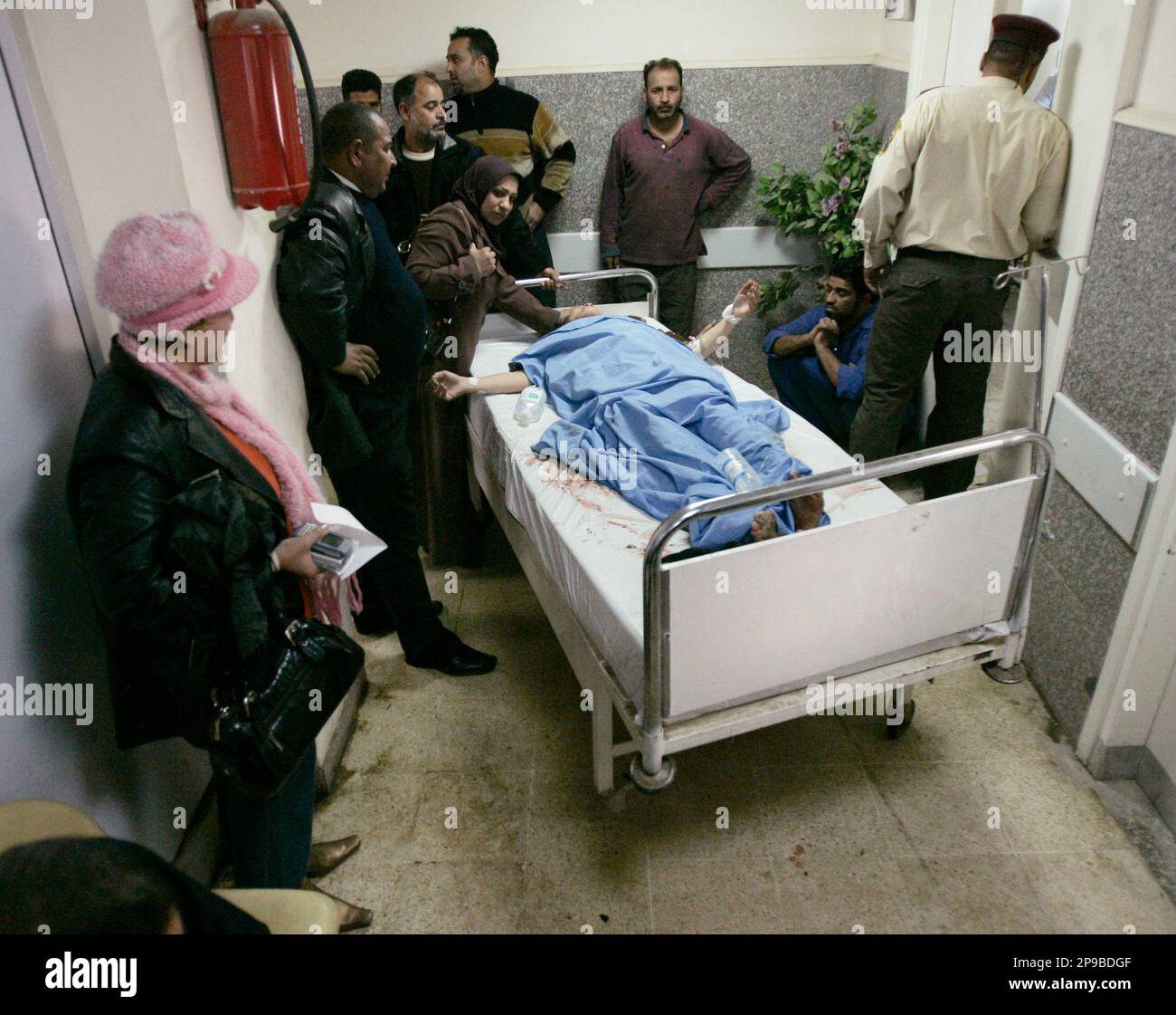 A woman lays on a hospital bed as she is treated at hospital in Baghdad ...