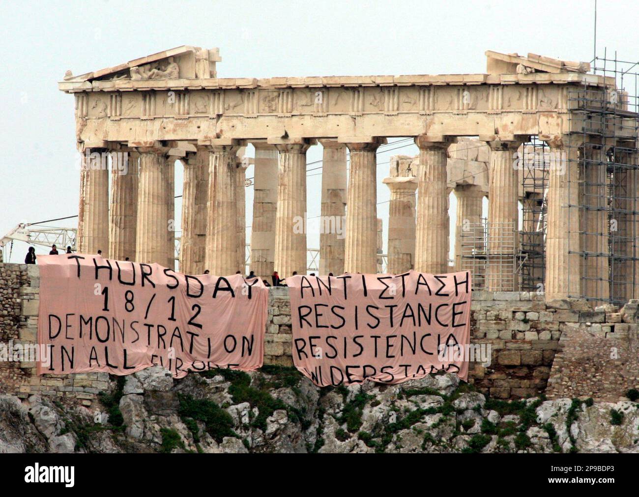 Backdropped by the ancient Parthenon, protesters can be seen after they ...