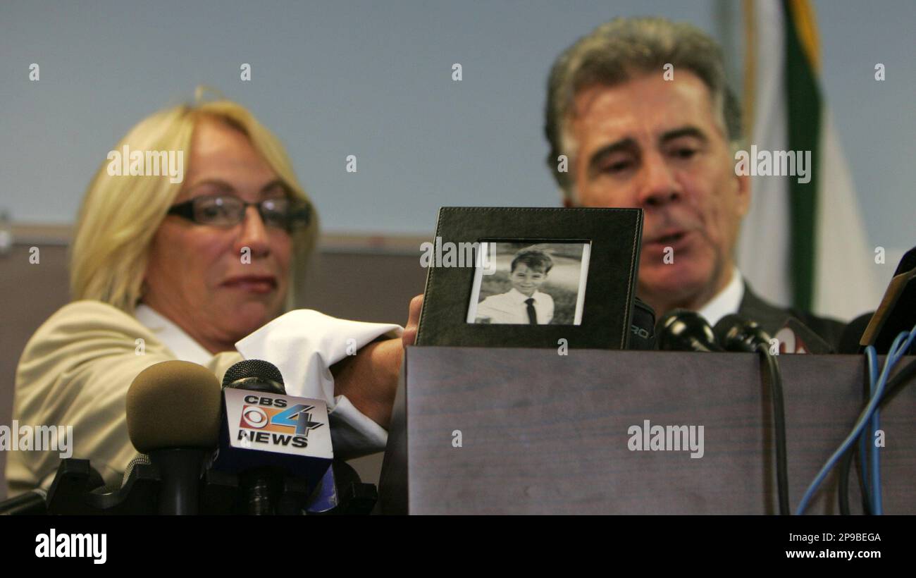 Reve Walsh displays a photo of her son, Adam, as her husband, John ...