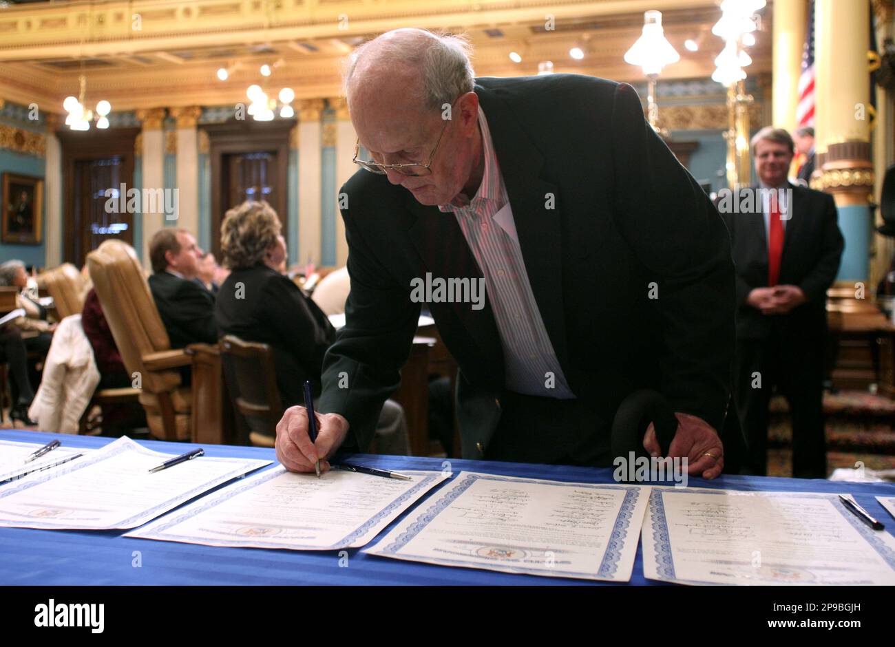 Arthur Shy, a Michigan elector from Dearborn Heights, signs his name to ...