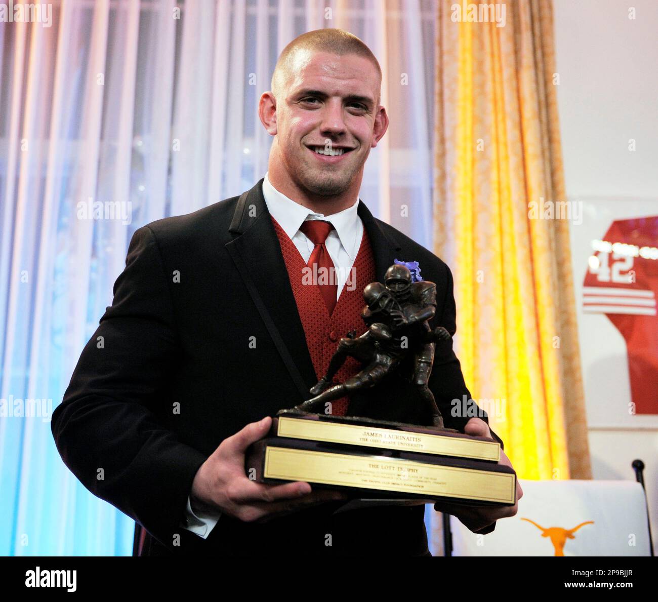 James Laurinaitis, of Ohio State, left, poses with the The Lott Trophy ...