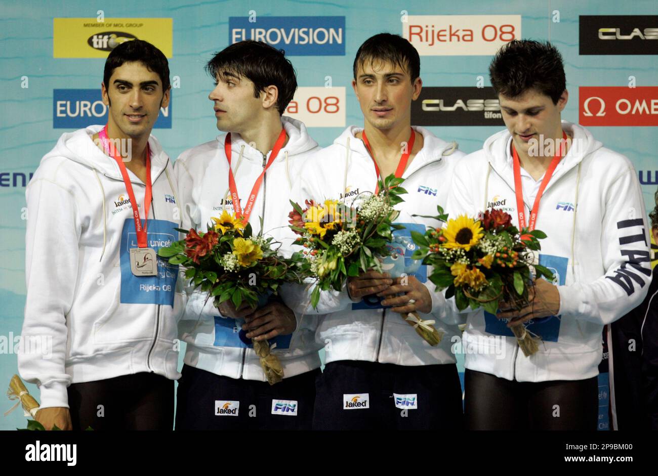 Team of Italy celebrates on the podium after placing second in Men's 4 ...