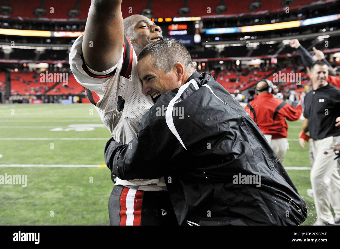 Cairo head coach Tom Fallaw, right, celebrates his team's 28-14 win ...