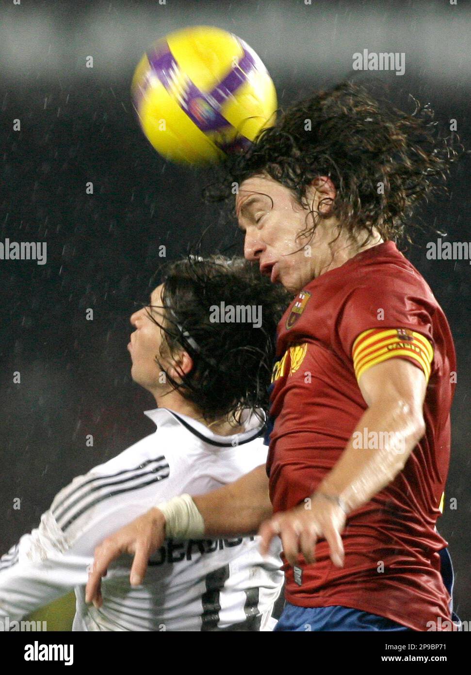 FC Barcelona's Carles Puyol from Spain , rights, fights for the ball ...