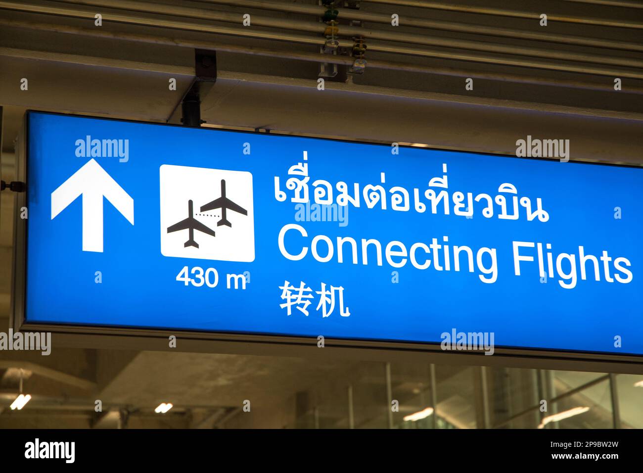 Airport signs for transfer and connecting flights in Thai, English and ...