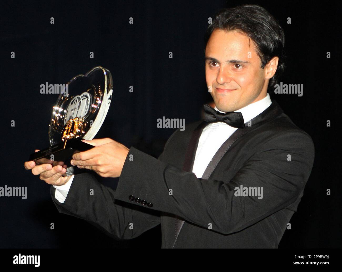 Brazilian Formula One driver Felipe Massa poses with his trophy during ...
