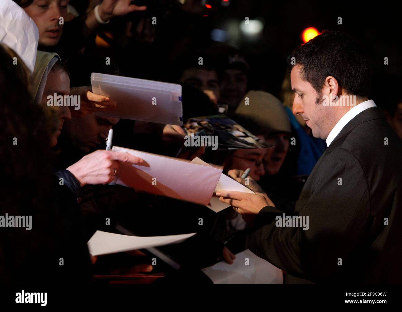 U.S. actor Adam Sandler, right, signs autographs for fans at the ...