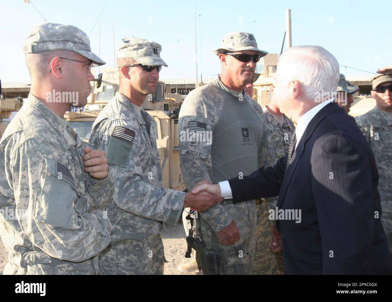 U.S. Defense Secretary Robert Gates, right, shakes hand with U.S ...