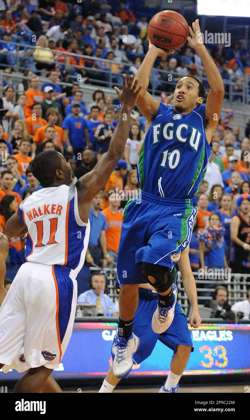 Florida Gulf Coasts' Ben Vega (10) shoots for three points against Florida's Erving Walker (11 ...