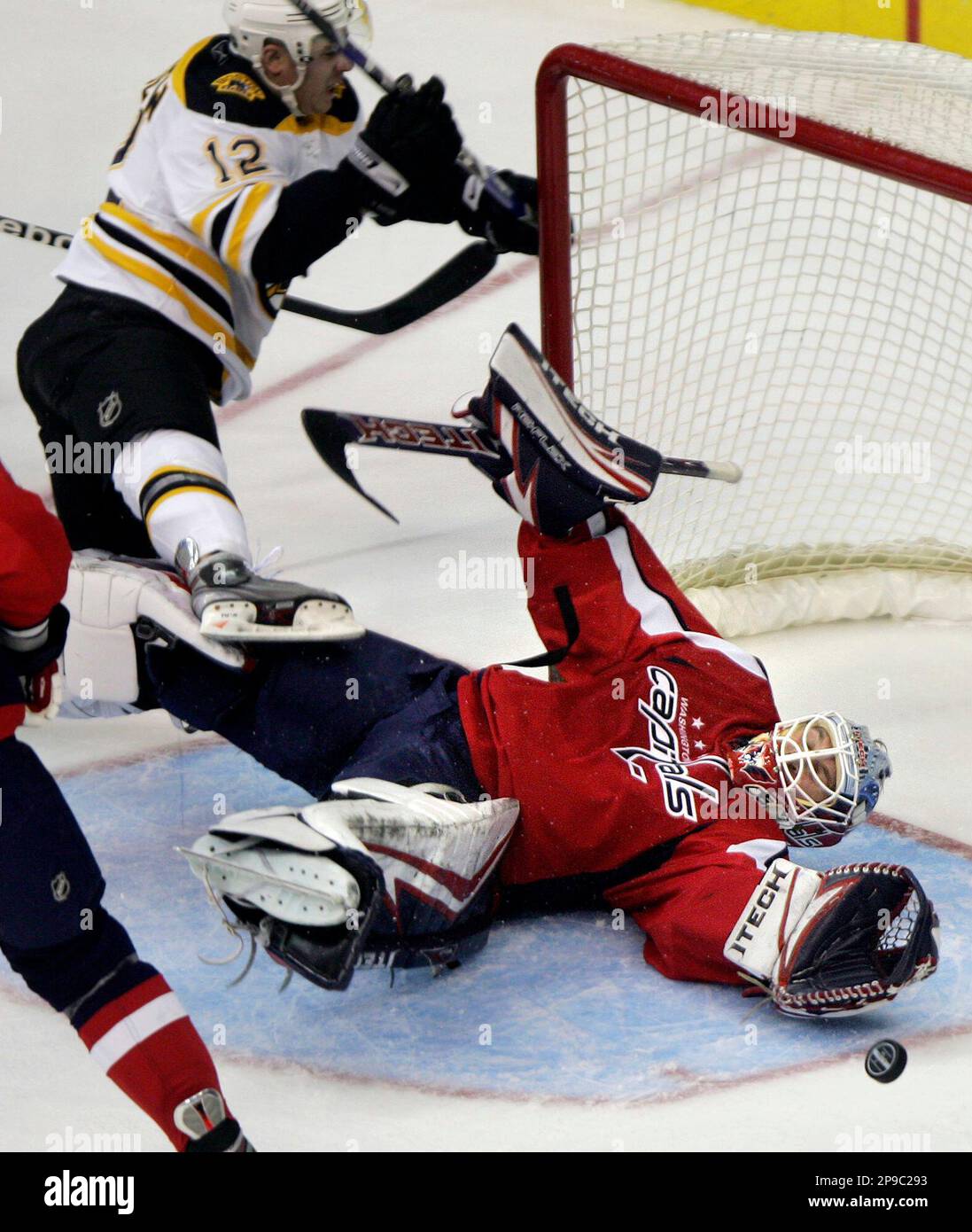 Washington Capitals goalie Brent Johnson blocks a shot by Boston Bruins ...