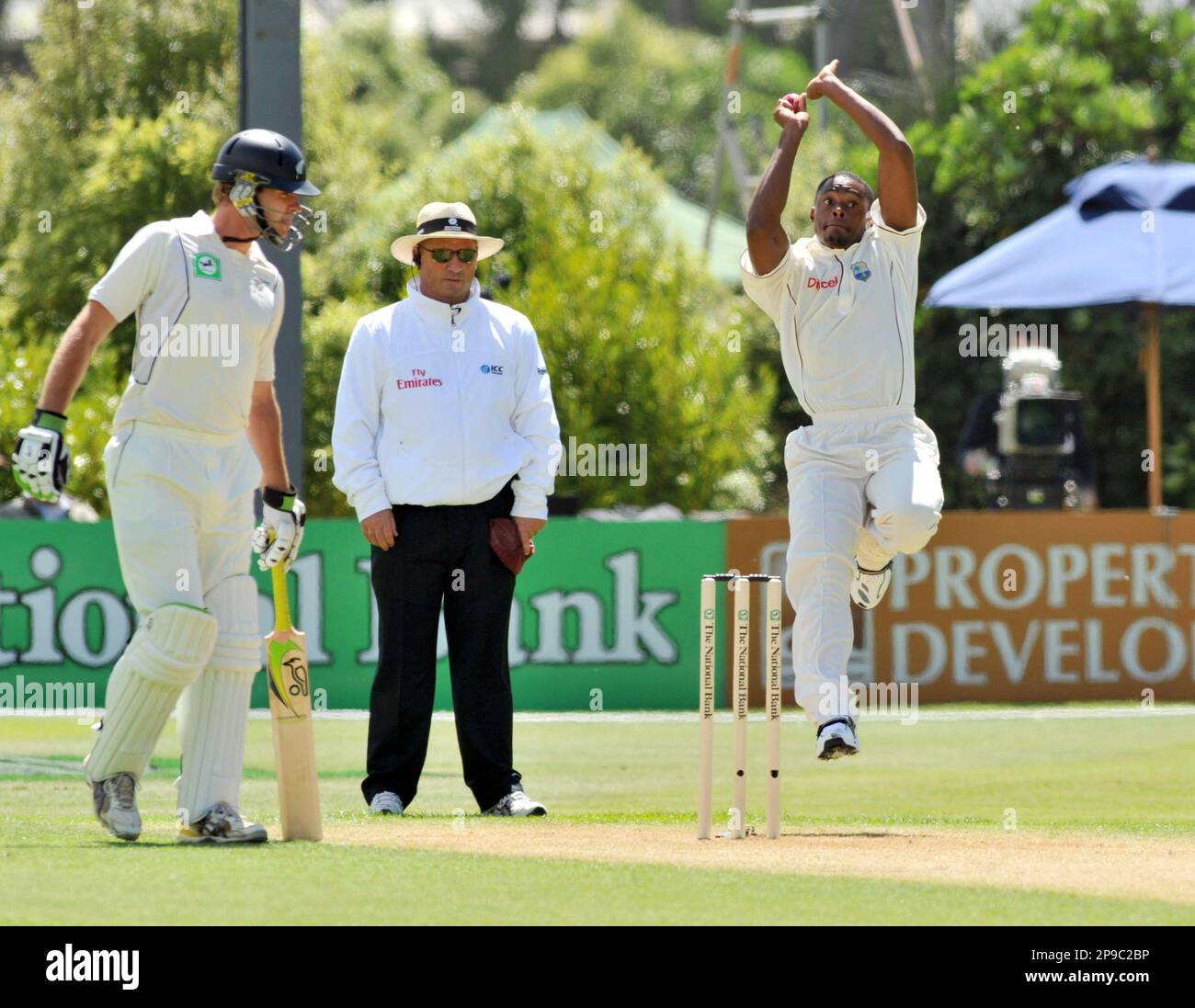 West Indies' Daren Powell, right, bowls past New Zealand's Tim ...